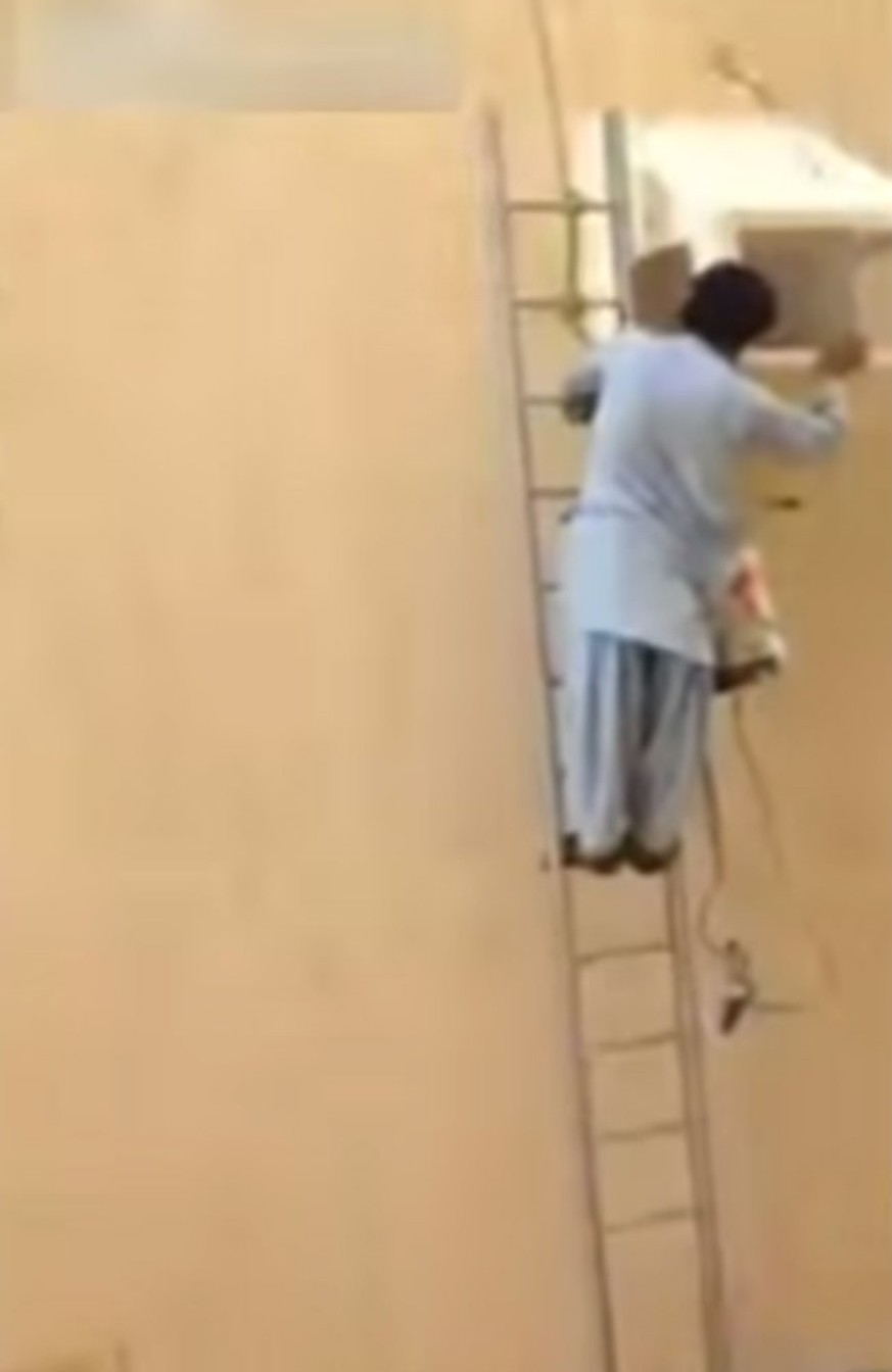 Dieser Inder steht auf einer Leiter und die Leiter geht erschreckend ...